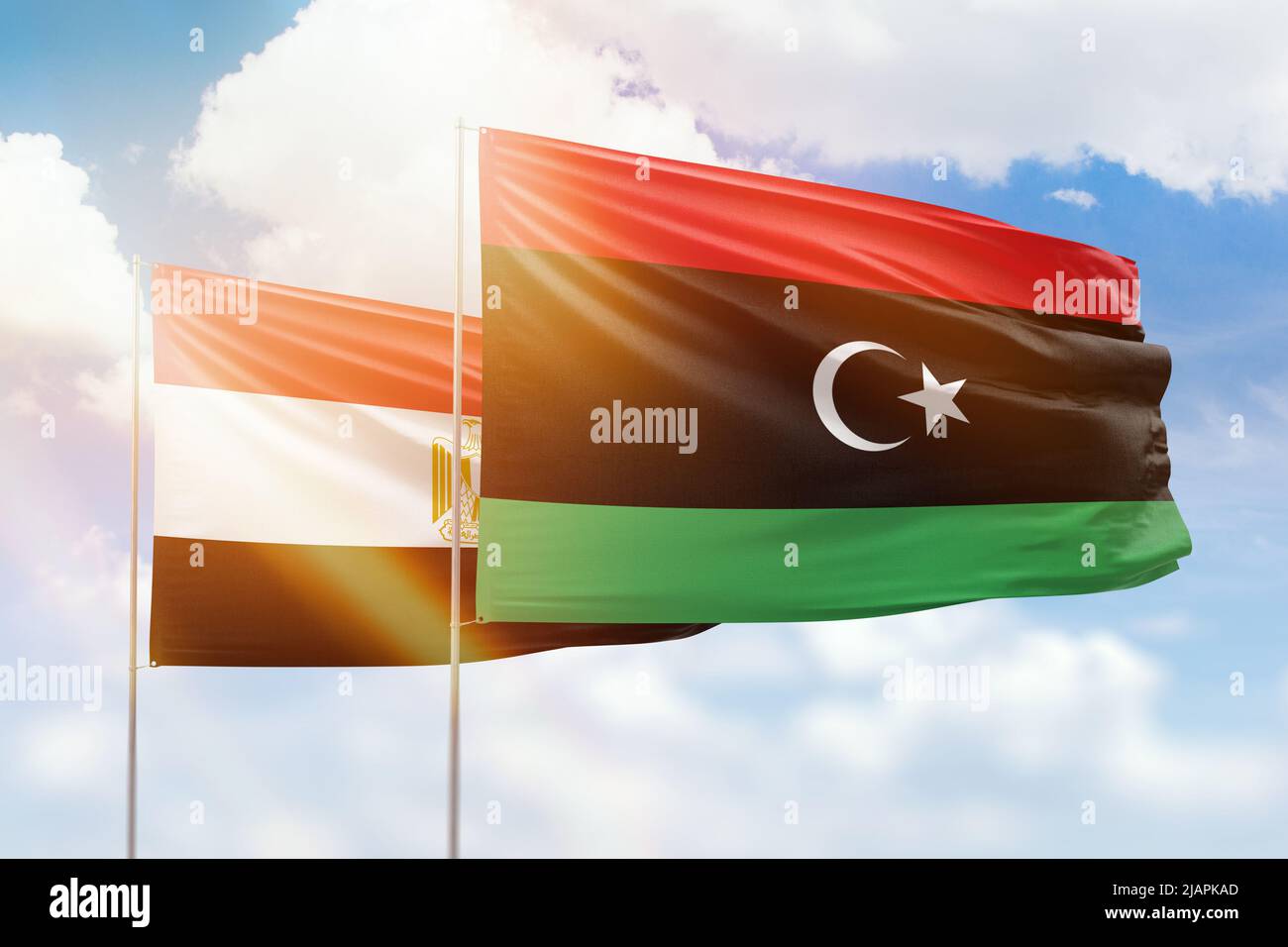 Sunny blue sky and flags of libya and egypt Stock Photo - Alamy