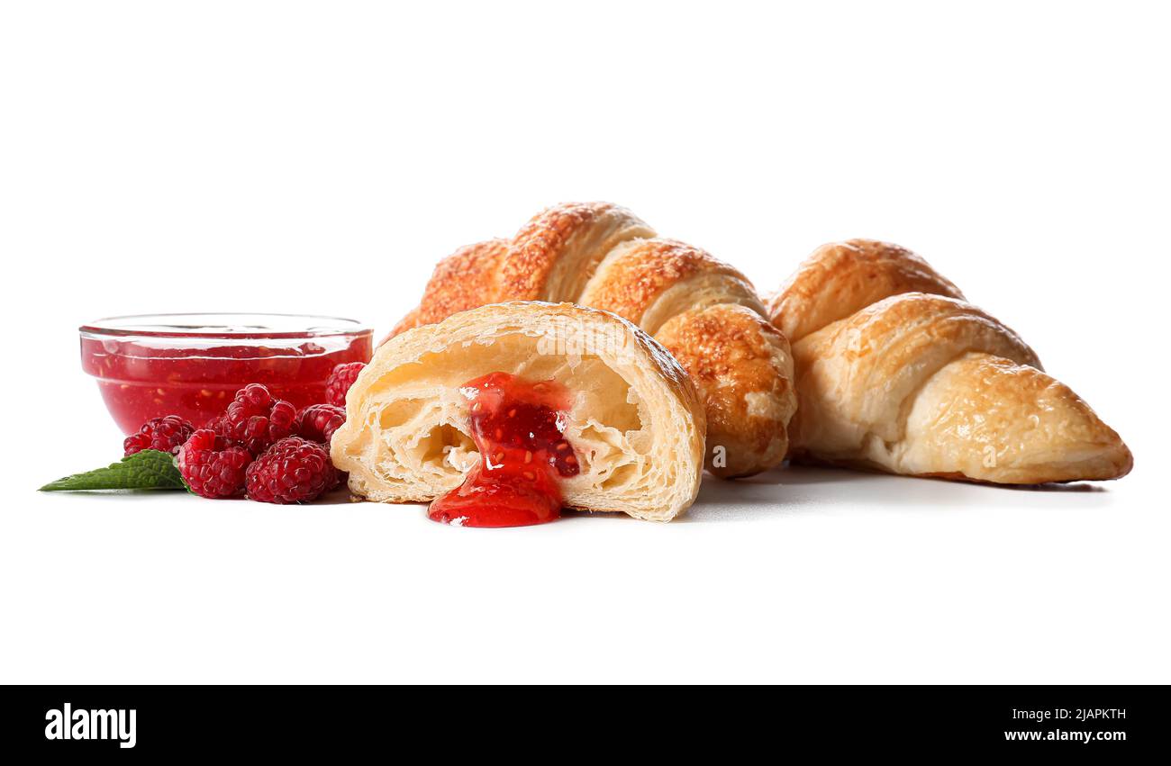 Delicious croissants with raspberry jam on white background Stock Photo ...