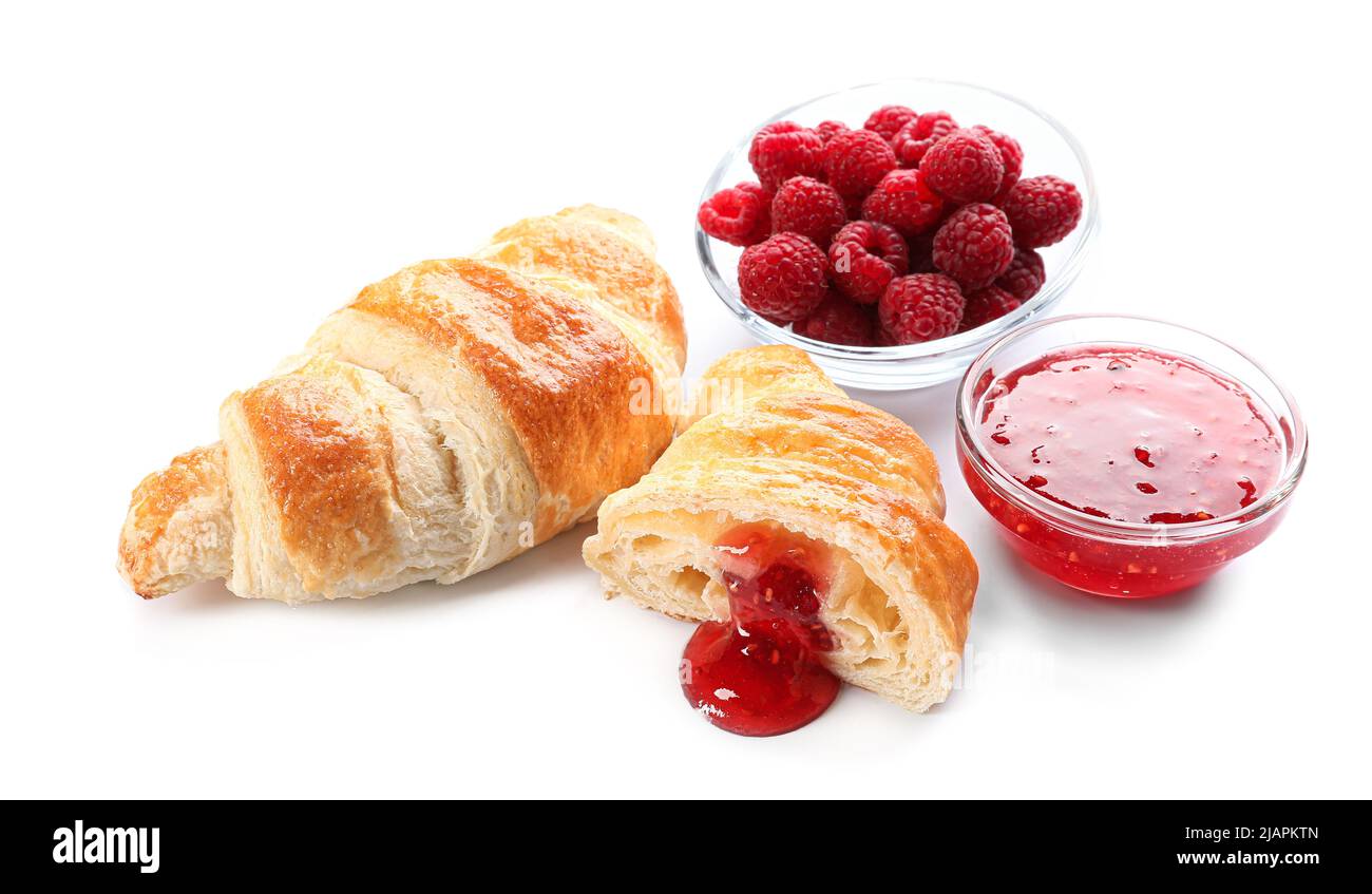 Delicious croissants with raspberry jam on white background Stock Photo ...