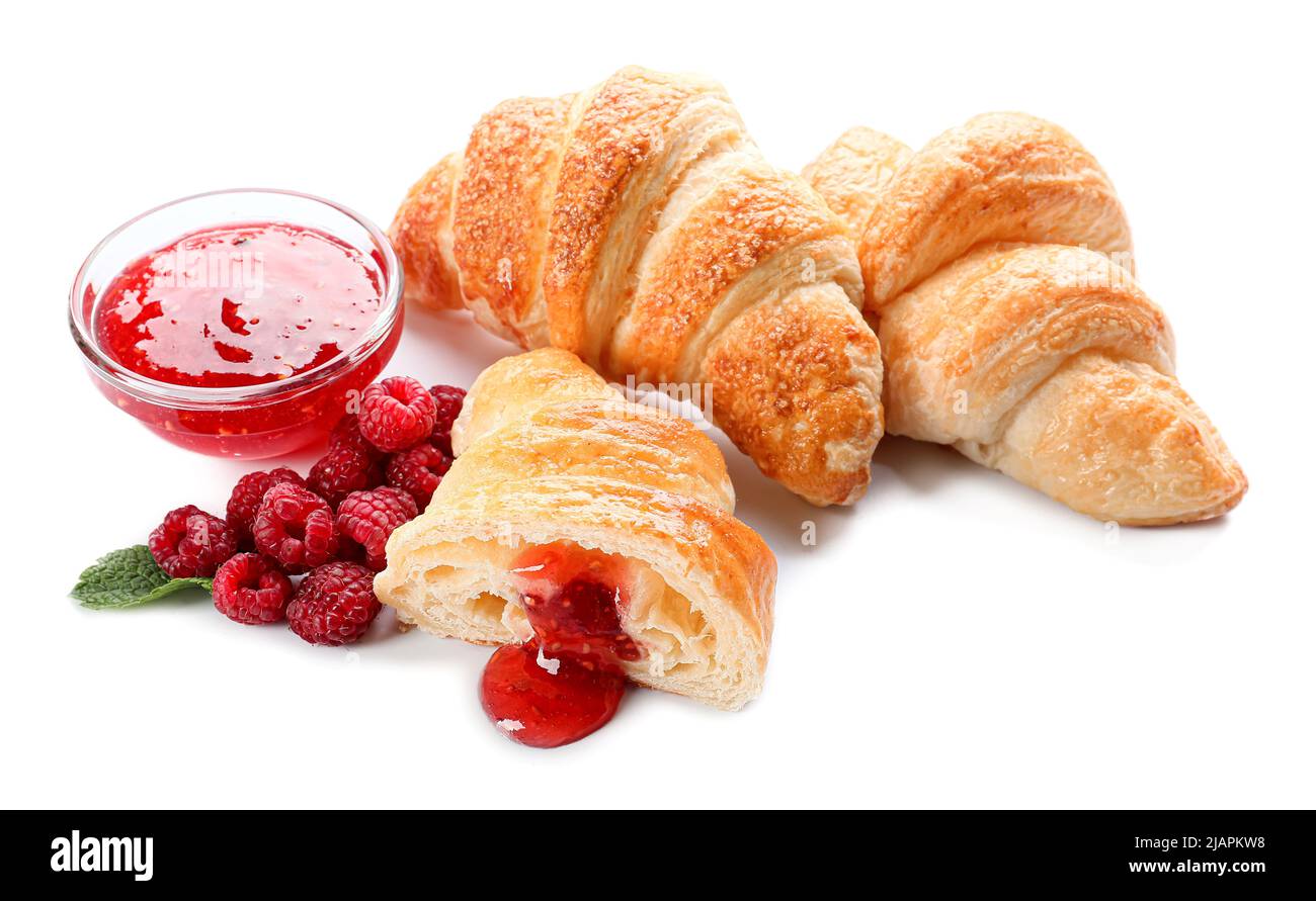 Delicious croissants with raspberry jam on white background Stock Photo ...