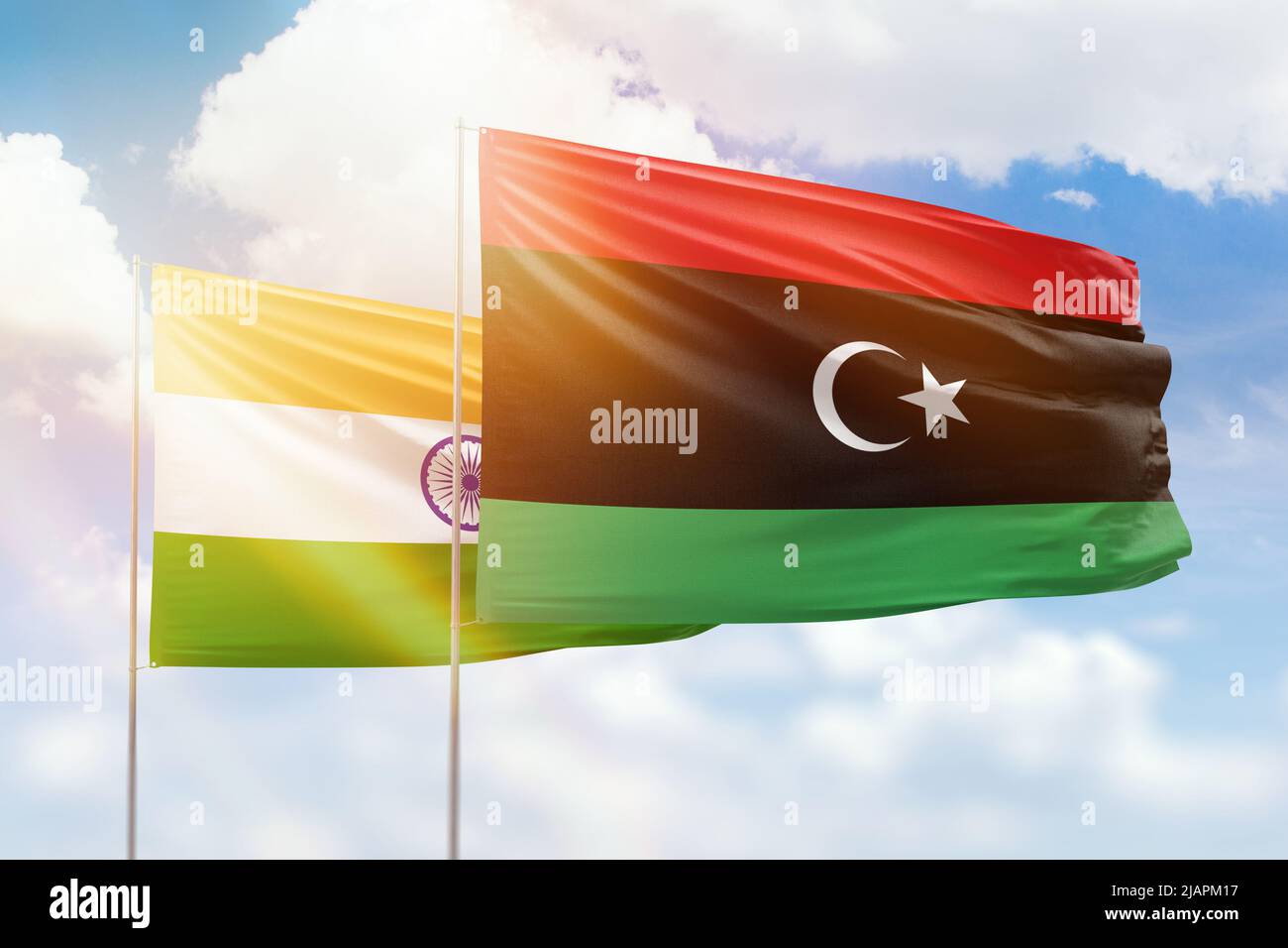 Sunny blue sky and flags of libya and india Stock Photo - Alamy