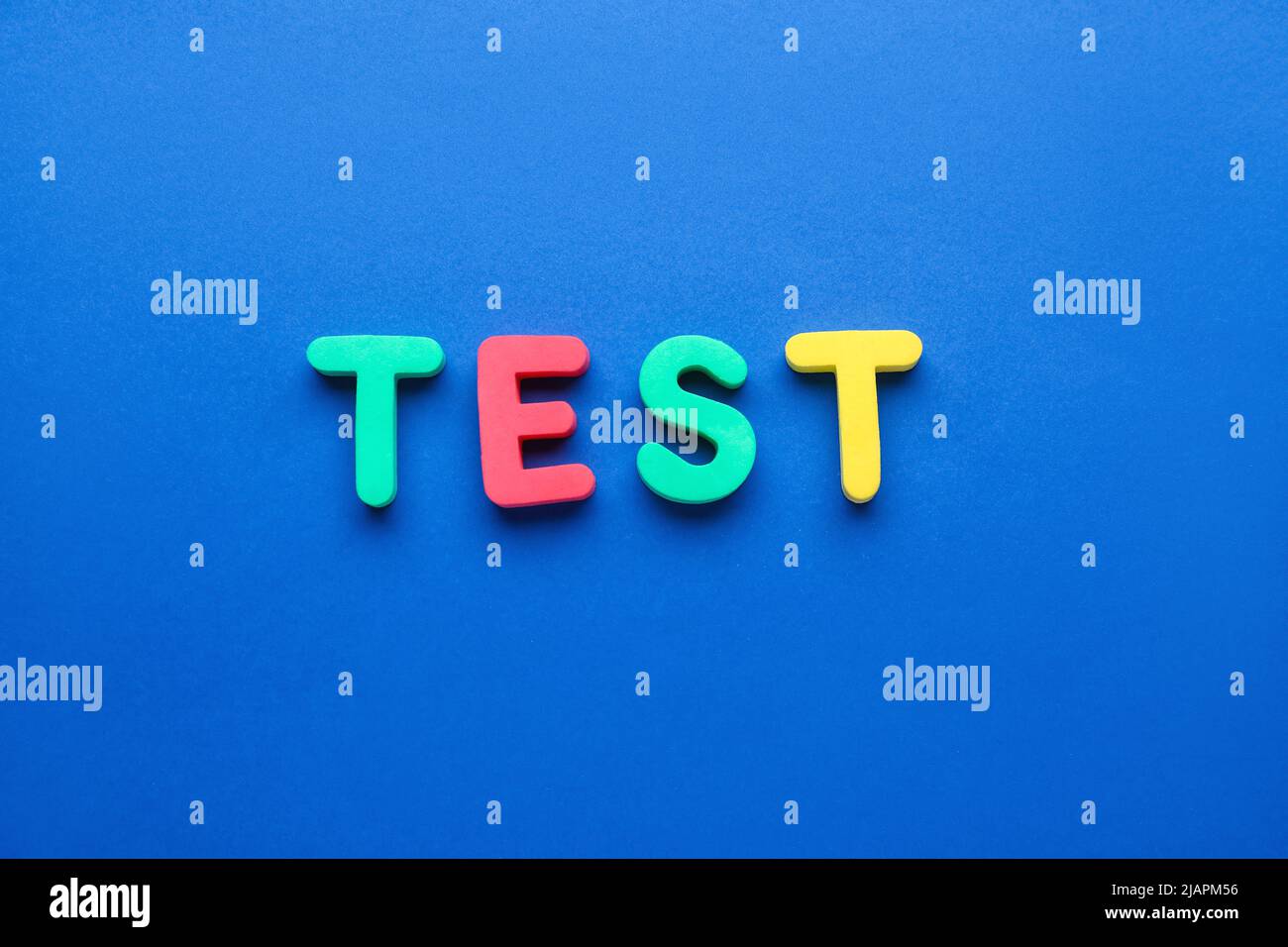 Word TEST on blue background Stock Photo - Alamy