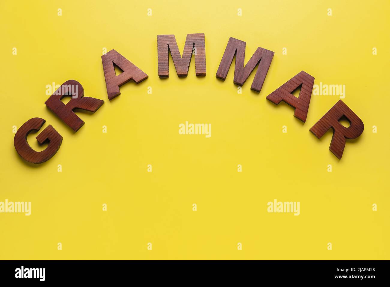 Word GRAMMAR on yellow background Stock Photo - Alamy