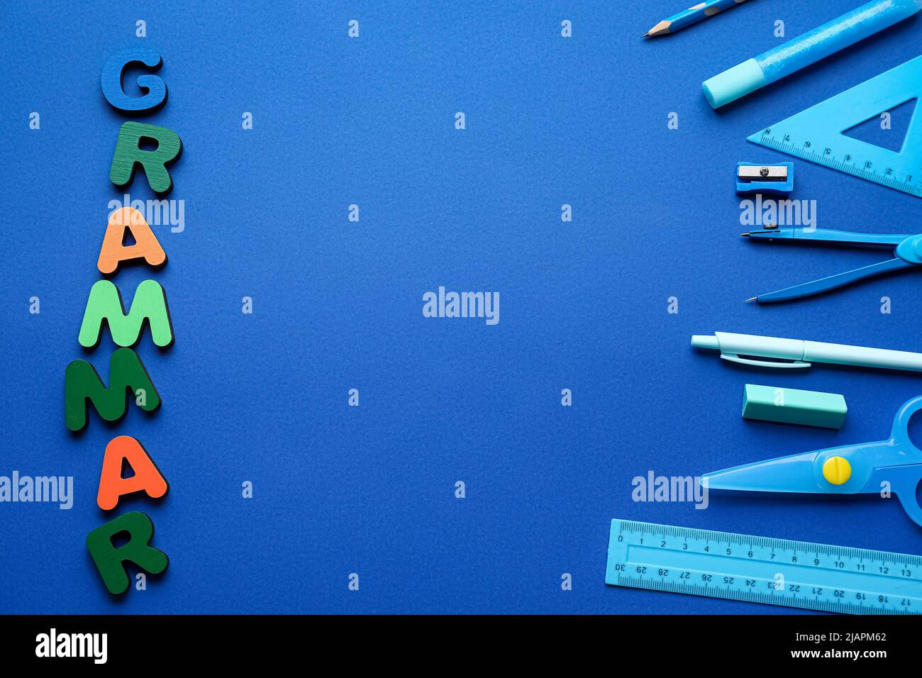 Word GRAMMAR and stationery on blue background Stock Photo - Alamy