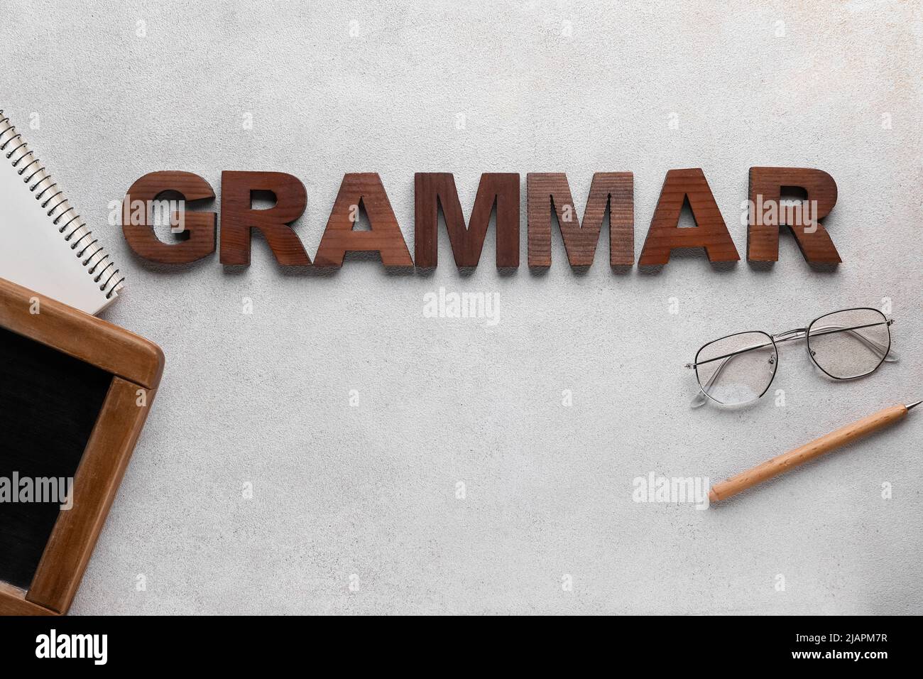 Word GRAMMAR with eyeglasses and pencil on light background Stock Photo ...