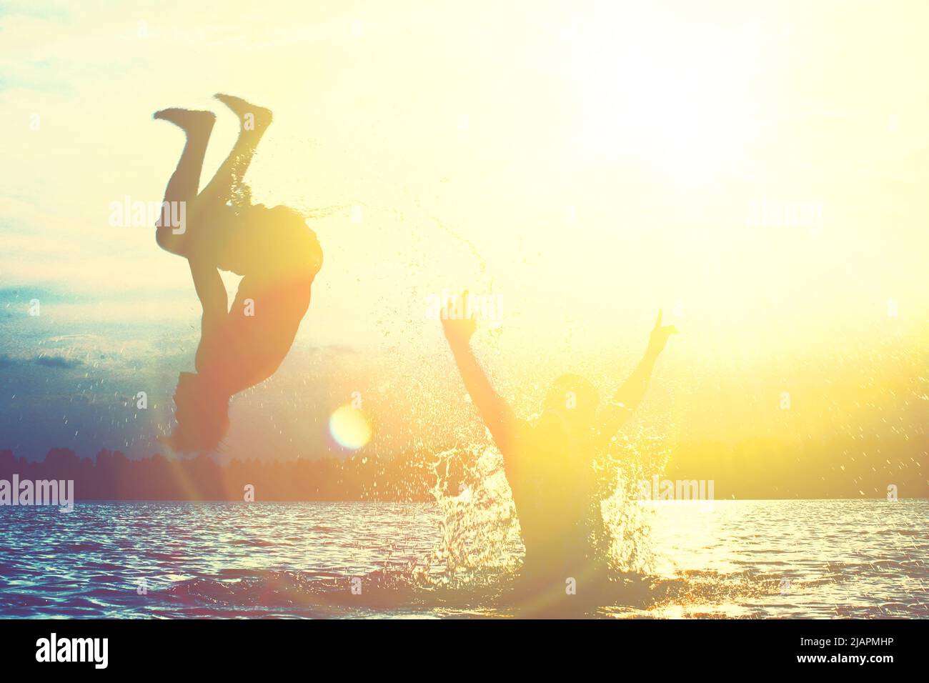Group of young people playing games on sandy beach on a summer day ...