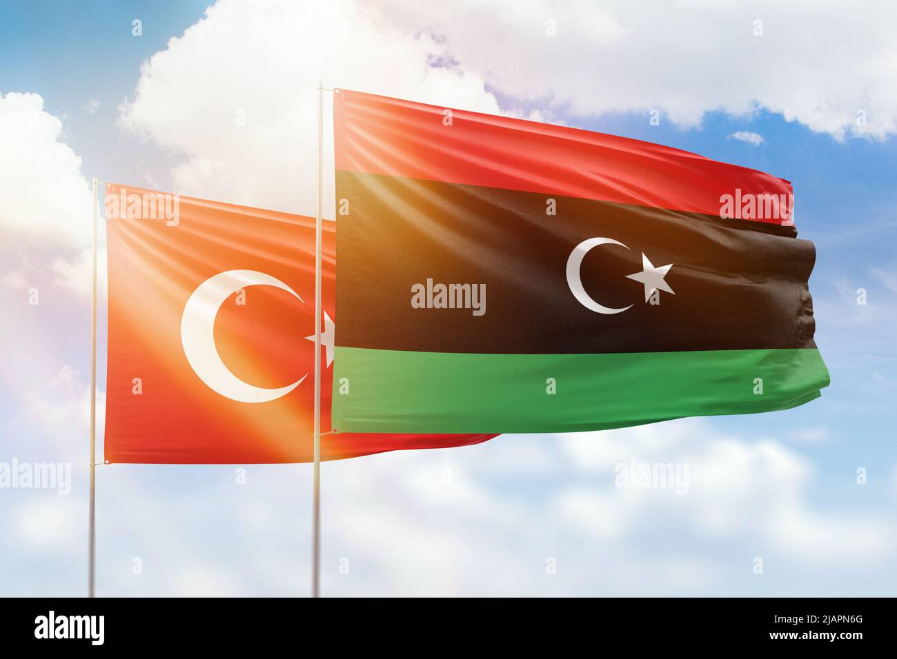 Sunny blue sky and flags of libya and turkey Stock Photo - Alamy