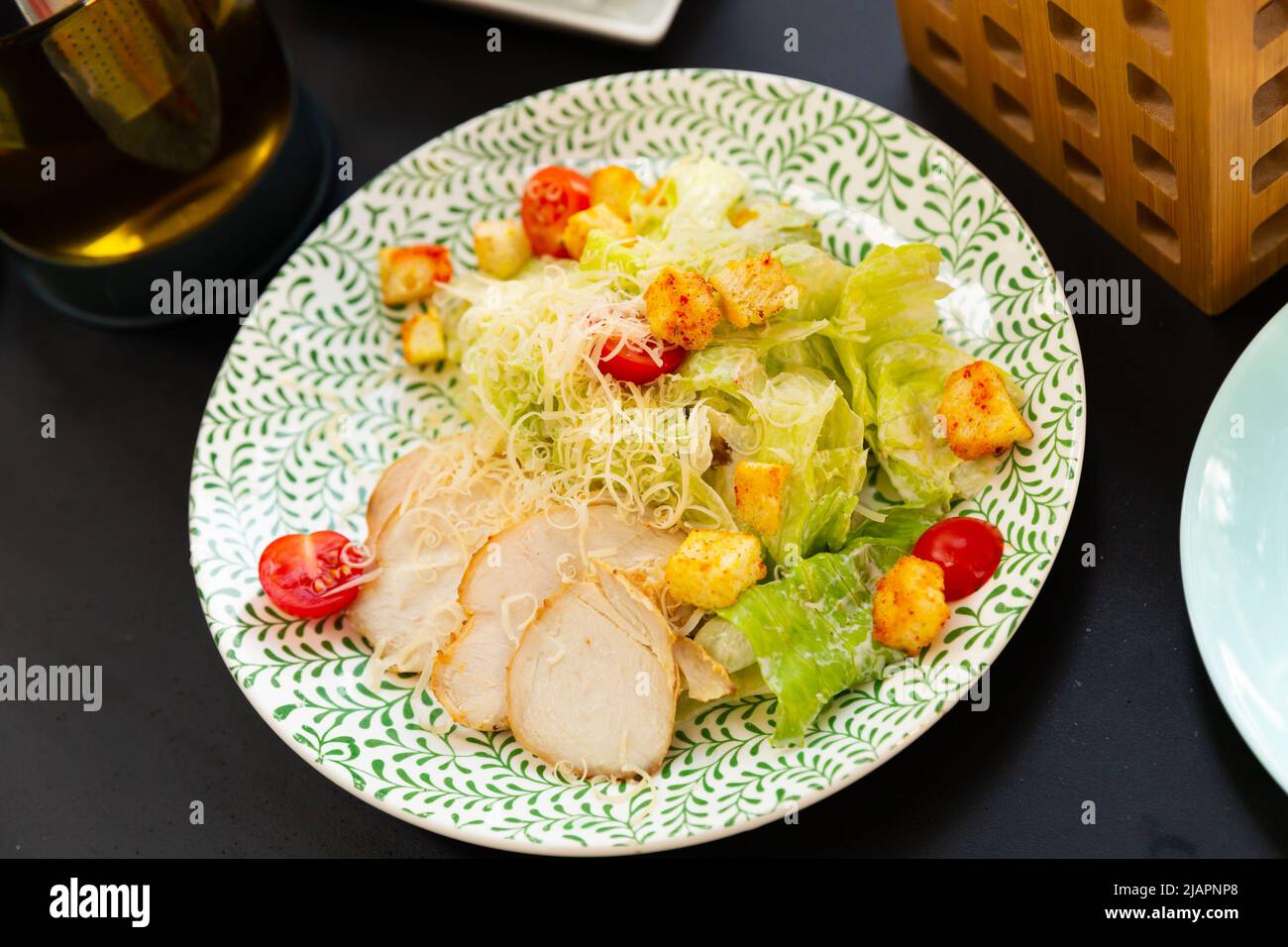 Chicken Caesar salad with tomatoes and cheese Stock Photo - Alamy
