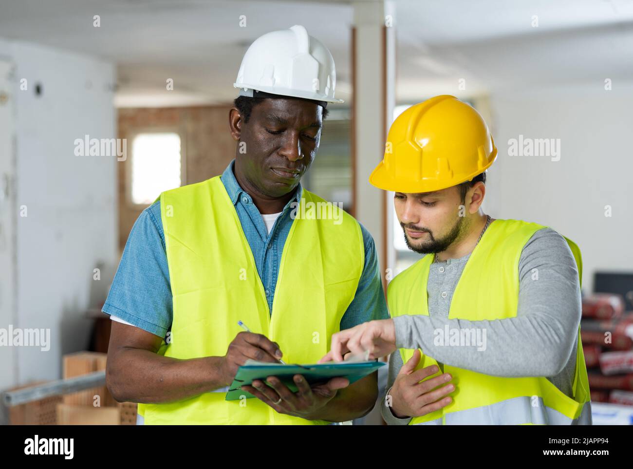 Foreman tells worker how and where to make repairs Stock Photo - Alamy