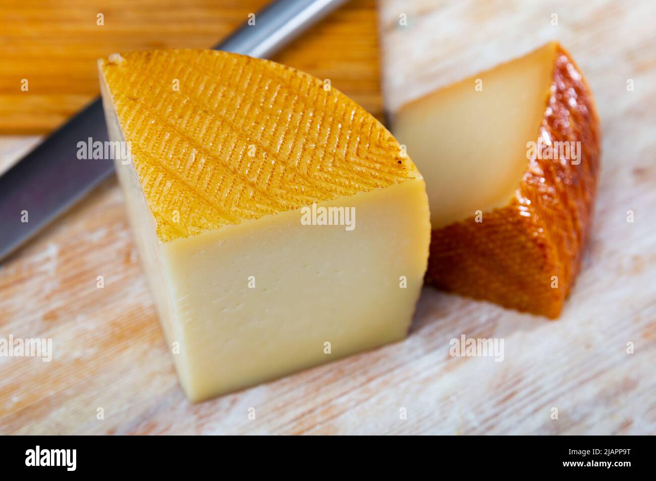 View of a pieces of semi-hard cheese Stock Photo - Alamy
