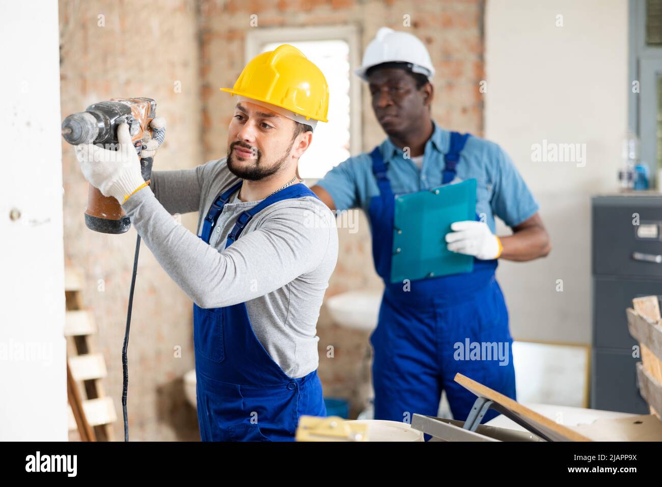 Man construction worker using demolition hammer in apartment Stock ...