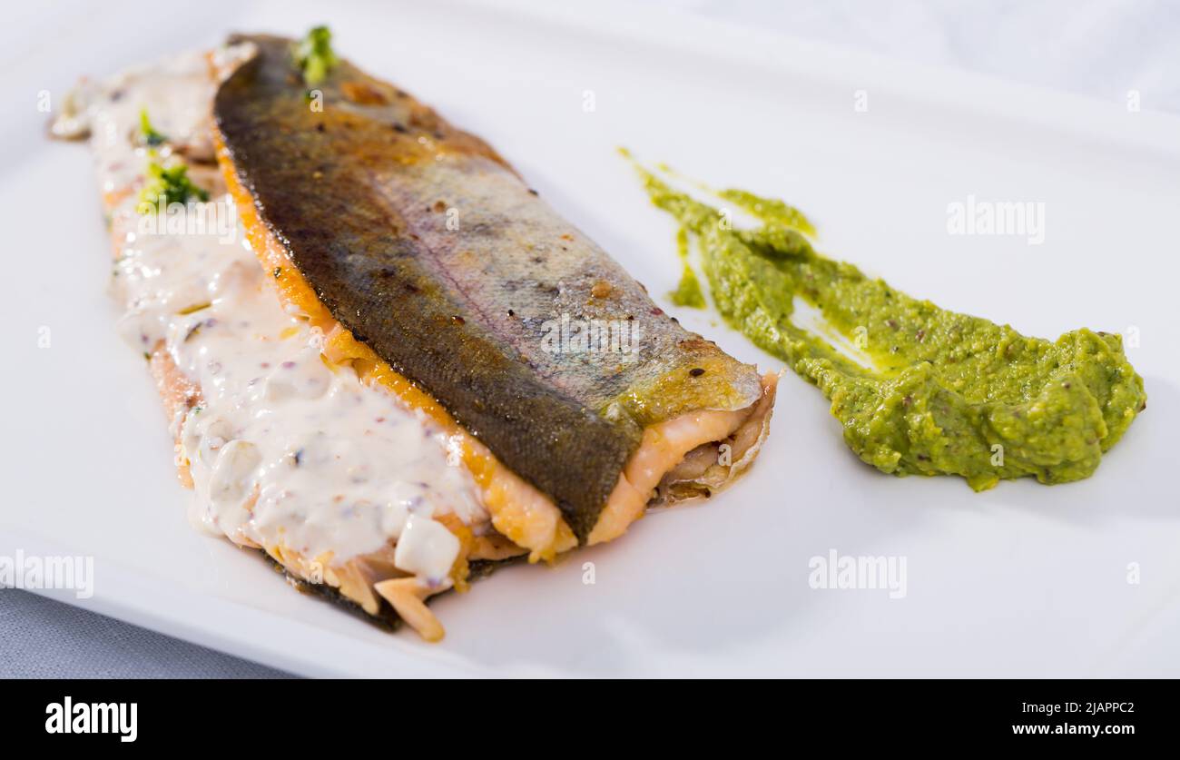 Tasty fried river trout fillet with sause tartar on plate Stock Photo ...