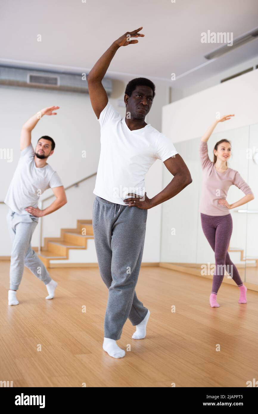African-american man practicing classical dance moves with group Stock ...