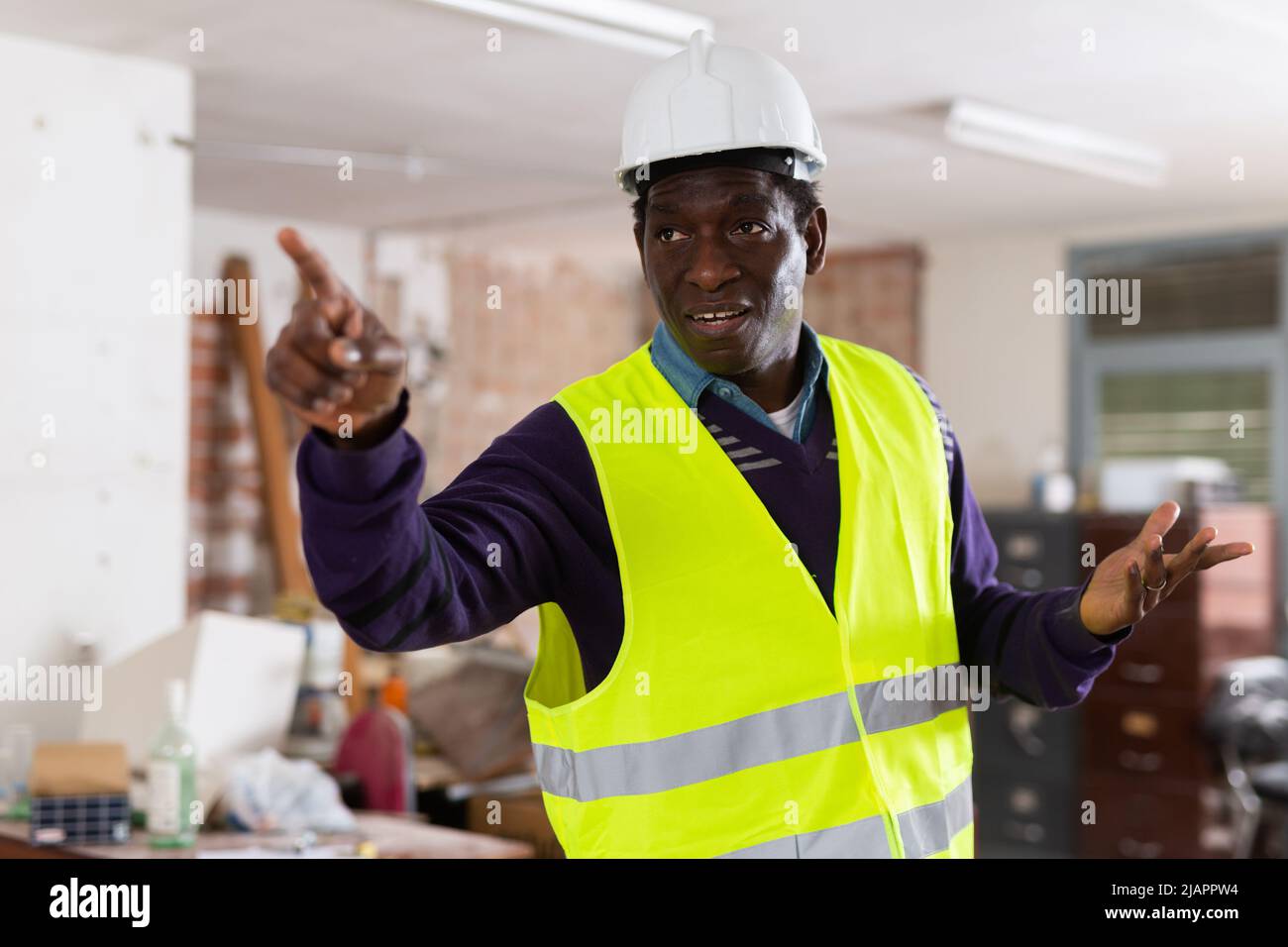 Worried puzzled architect standing in building during renovation Stock ...