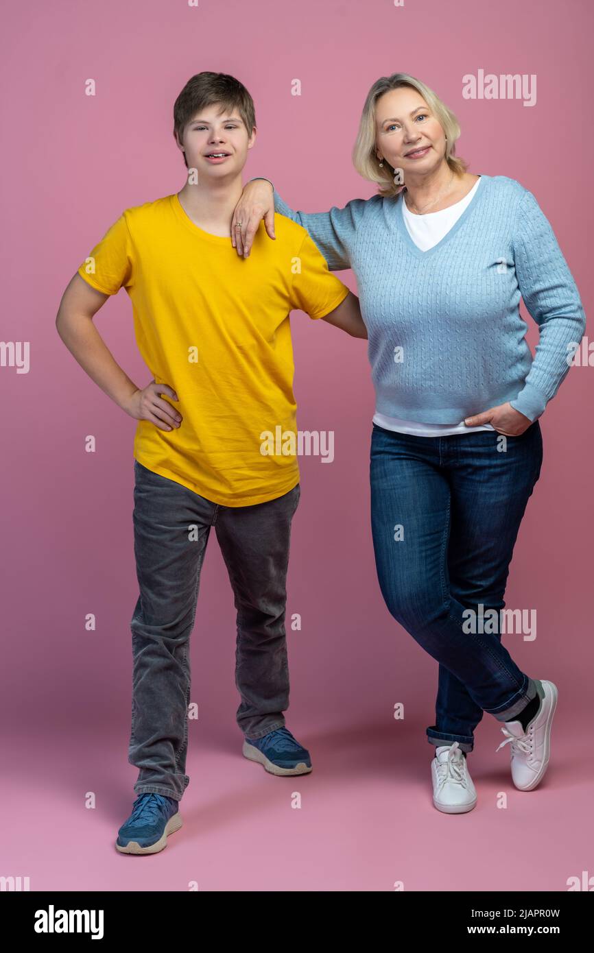Boy hugging mom posing for camera Stock Photo - Alamy
