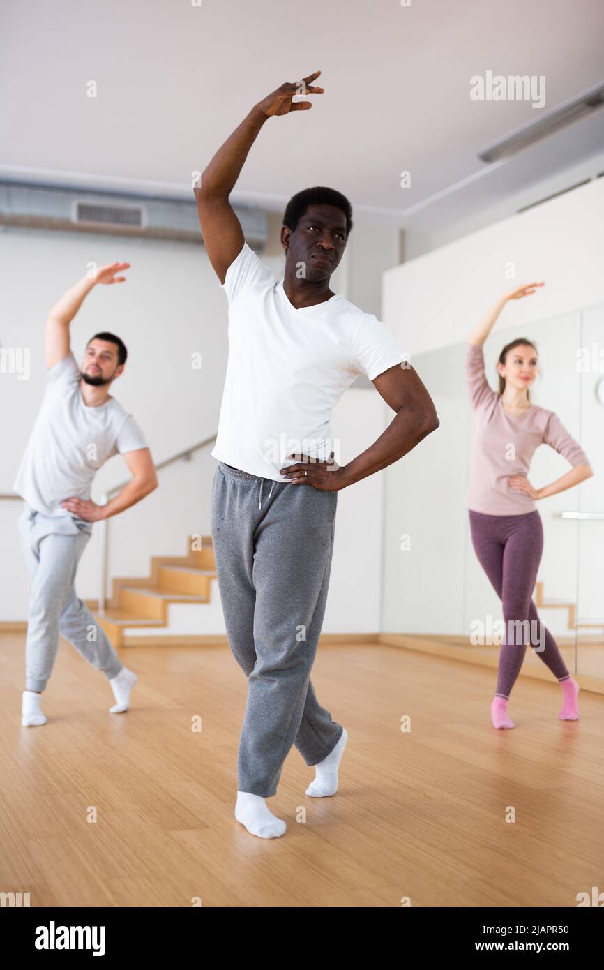 African-american man practicing classical dance moves with group Stock ...