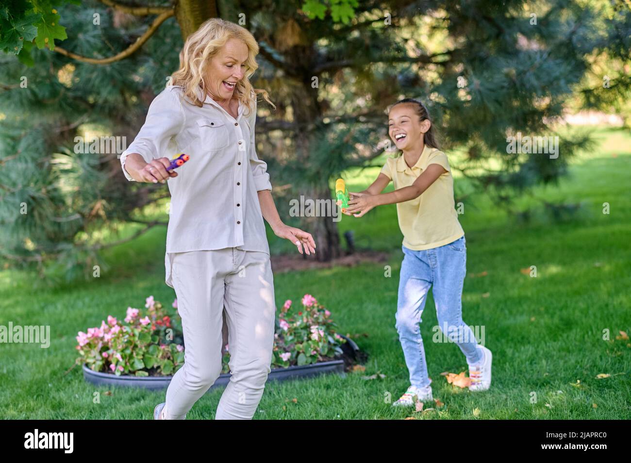 Mom and daughter playing in the park and looking happy Stock Photo - Alamy