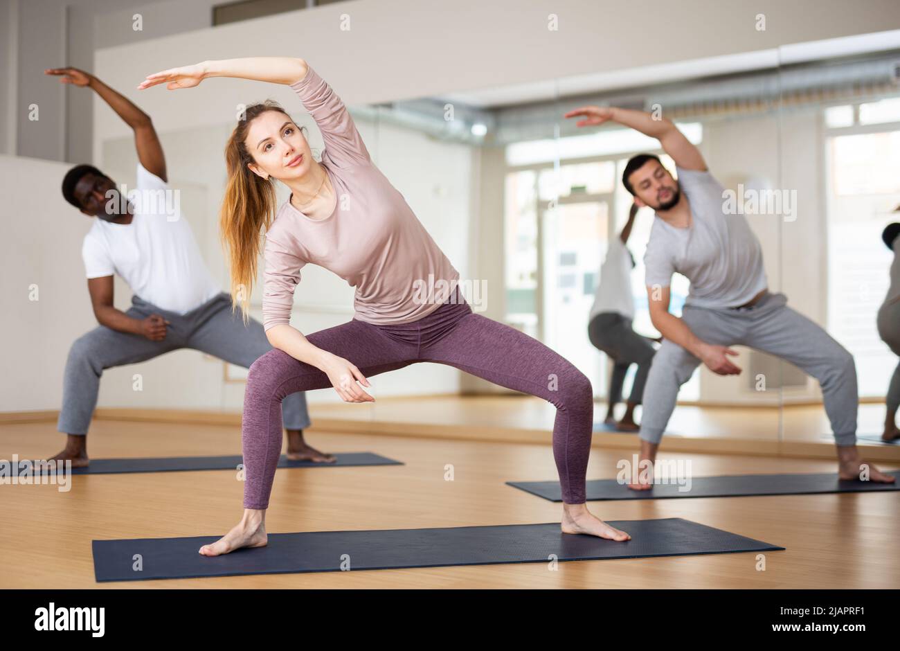 Group of people doing fitness exercises indoors Stock Photo - Alamy