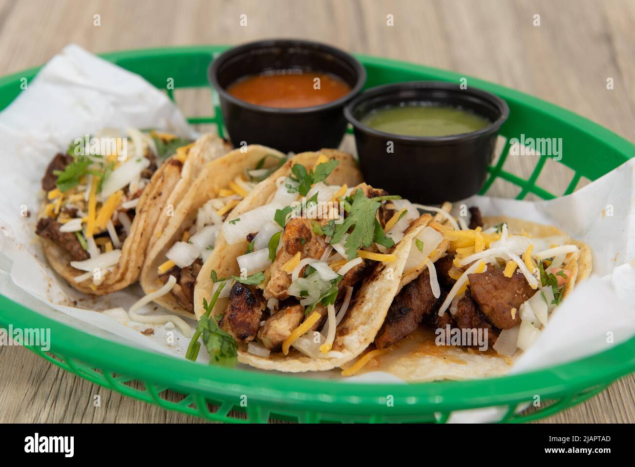 Loaded variety of tacos including chicken, steak, and pork served in a ...