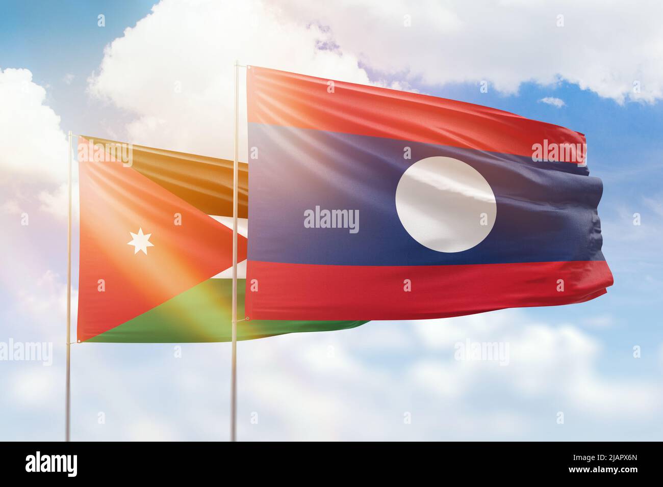 Sunny blue sky and flags of laos and jordan Stock Photo - Alamy