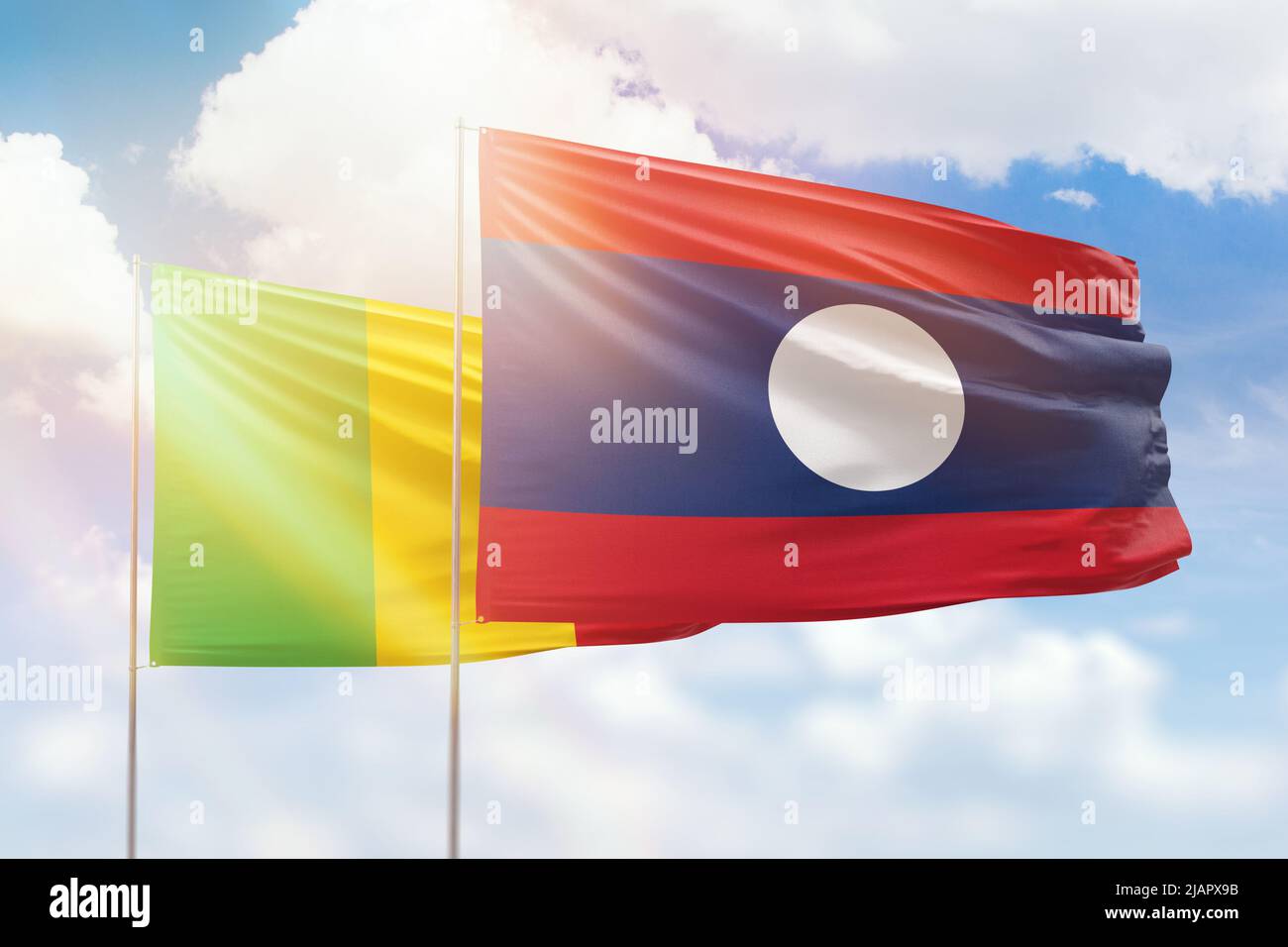 Sunny blue sky and flags of laos and mali Stock Photo - Alamy