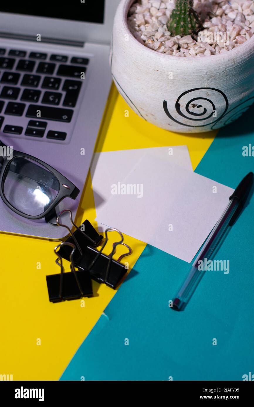 Office desk with yellow stickers, coffee and laptop. Top view flat lay ...