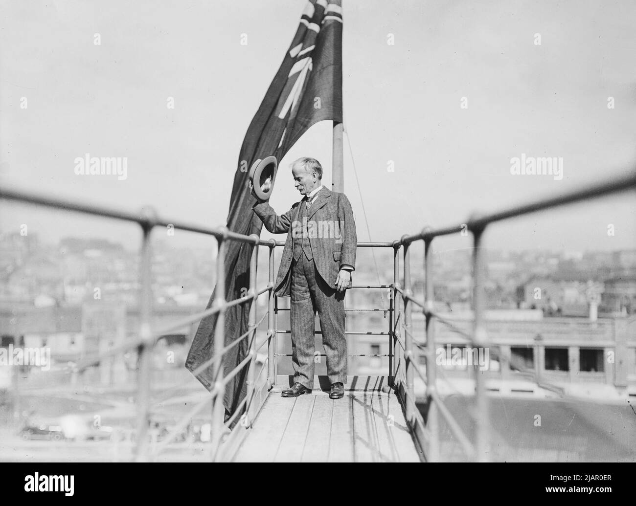 Australian engineer John Bradfield, tipping his hat from a walkway on ...