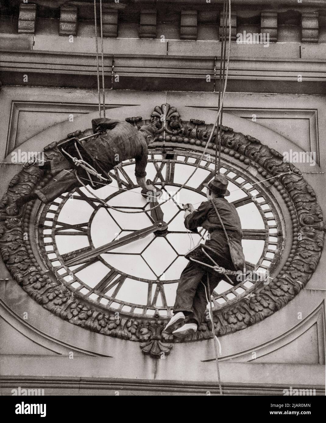 Photograph of cleaners on the clock face of Sydney Town Hall ca. 1937 ...
