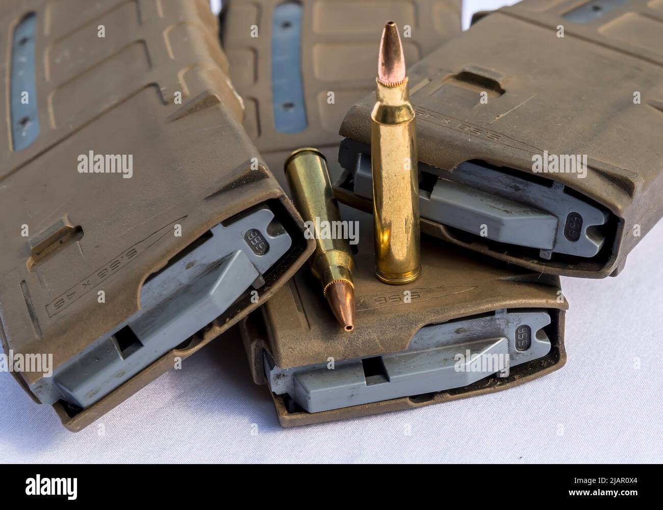 Three AR 15 magazines with bullets for them on a white background Stock ...