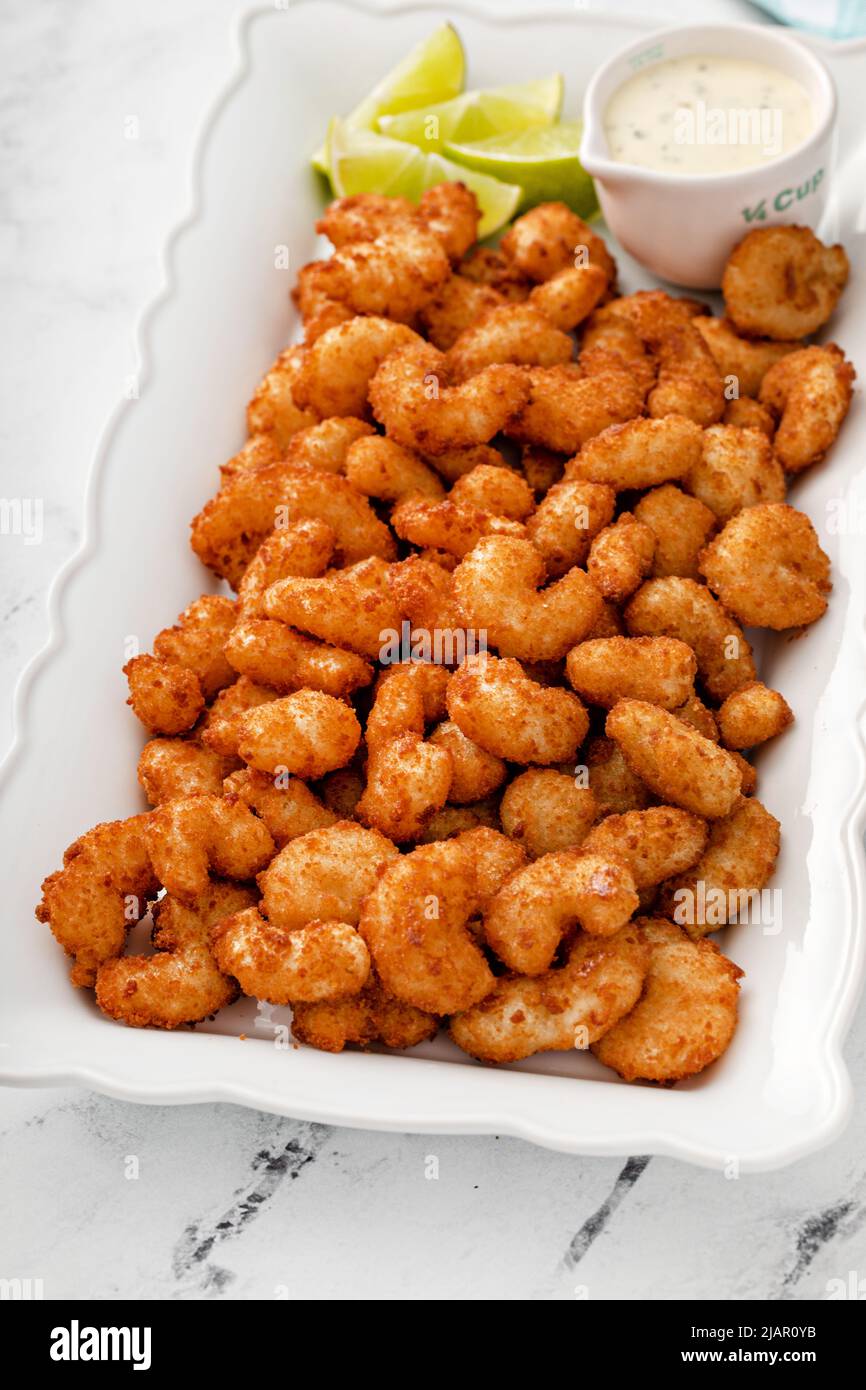 Coconut shrimp with ranch dip and lime wedges Stock Photo - Alamy