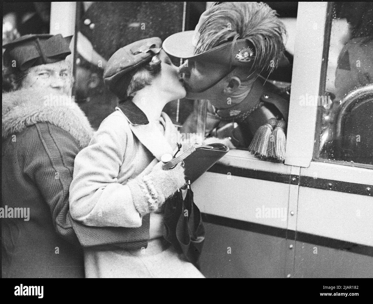 Man and woman exchange a kiss, arrival of Coronation Contingent which ...