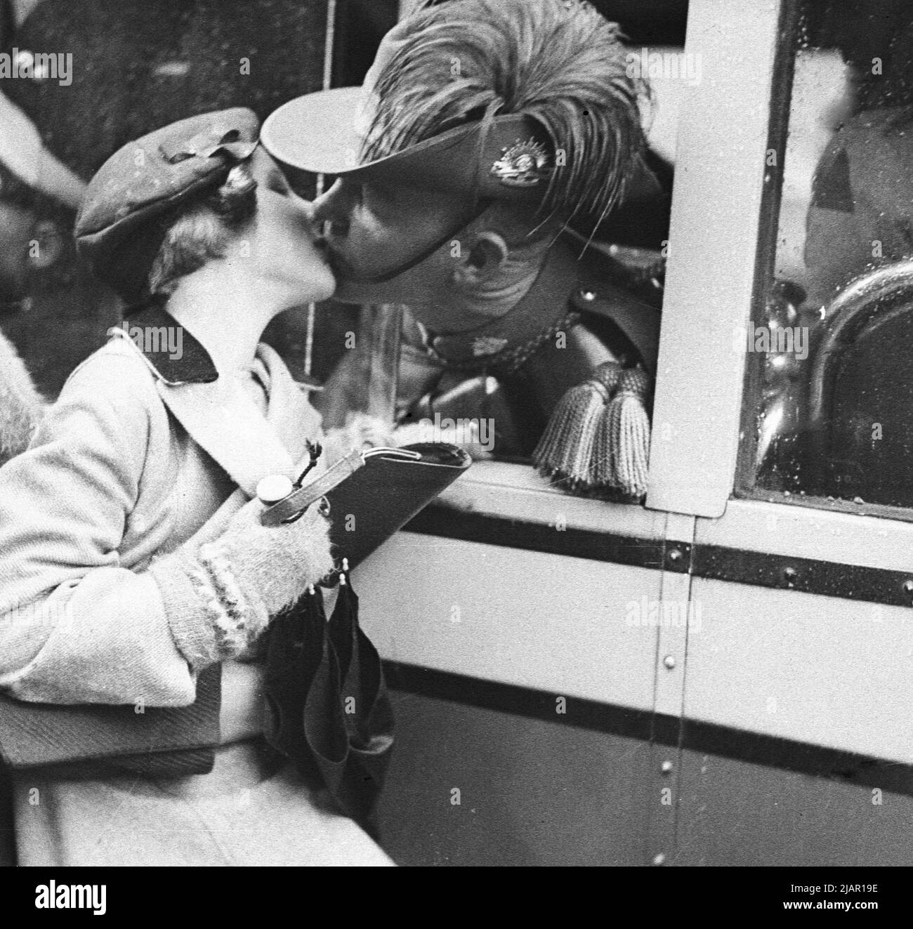 Man and woman exchange a kiss, arrival of Coronation Contingent which ...