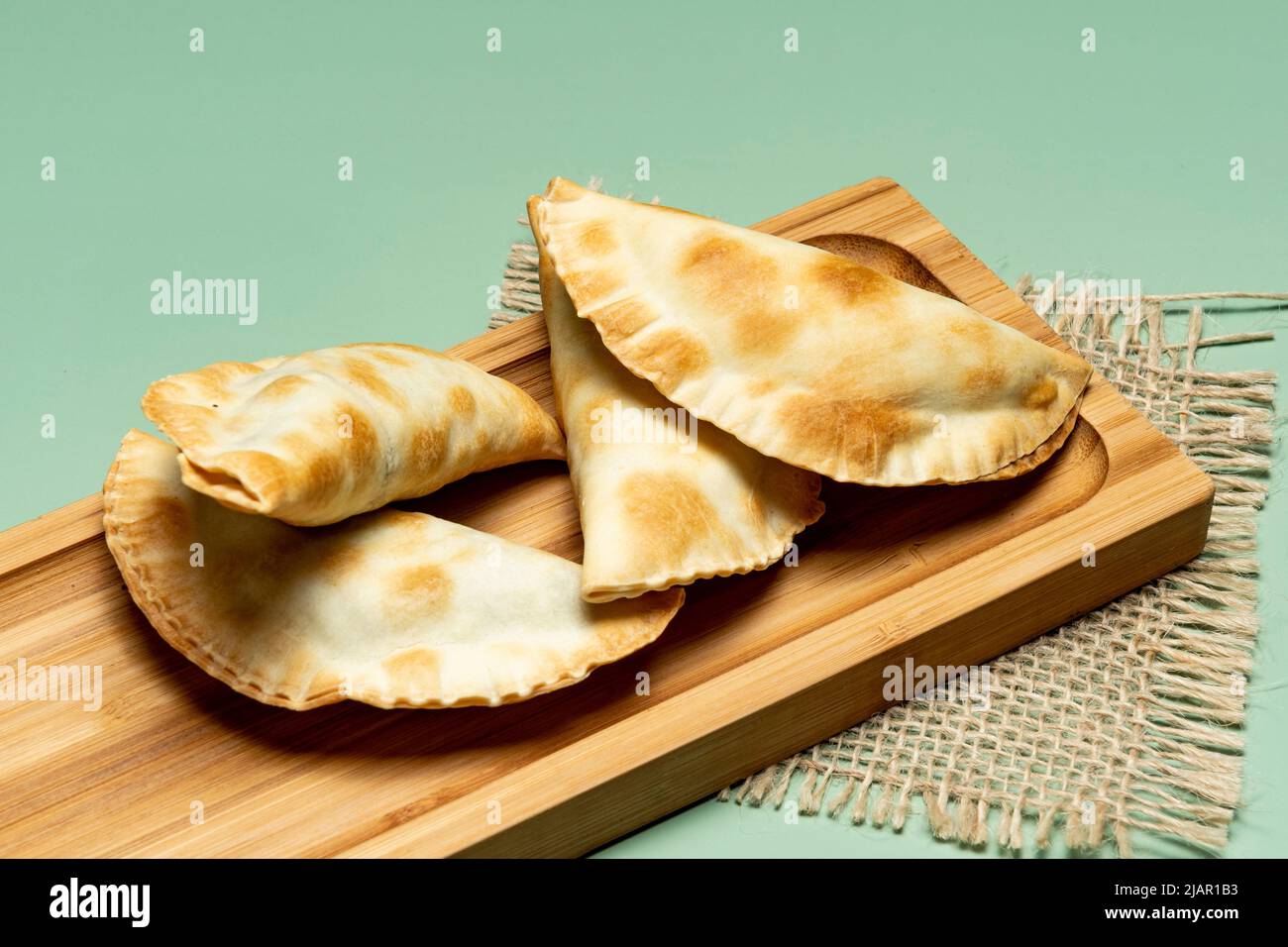 portion of bar meat pastries in a green background Stock Photo - Alamy