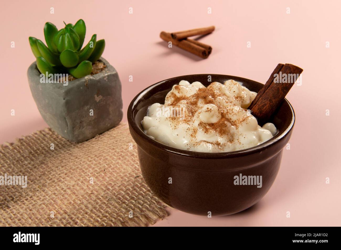 Brazilian sweet dessert, Canjica. White corn porridge with cinnamon and ...