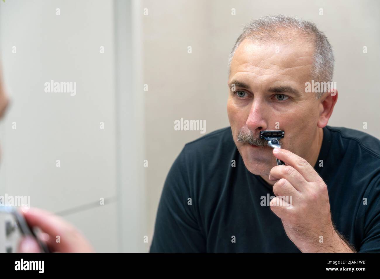 Man shaving with razor using foam in bathroom in the morning Stock ...