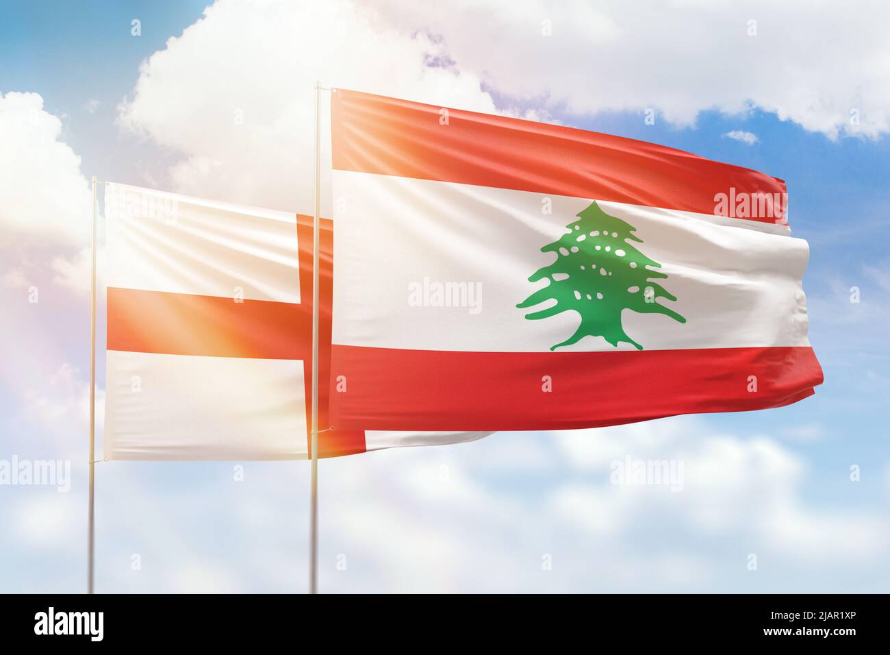 Sunny blue sky and flags of lebanon and england Stock Photo - Alamy