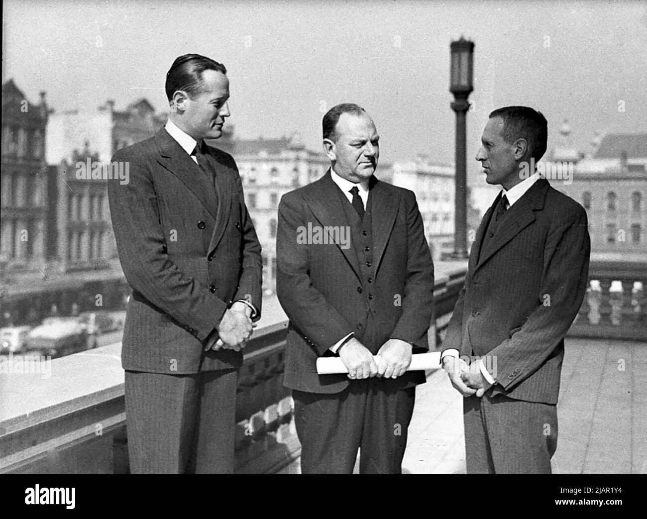 Three well dressed men wearing suits, standing outside, probably in ...