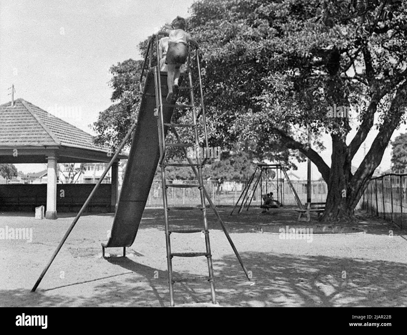 Children playing on a slippery dip or a slide at a playground in ...
