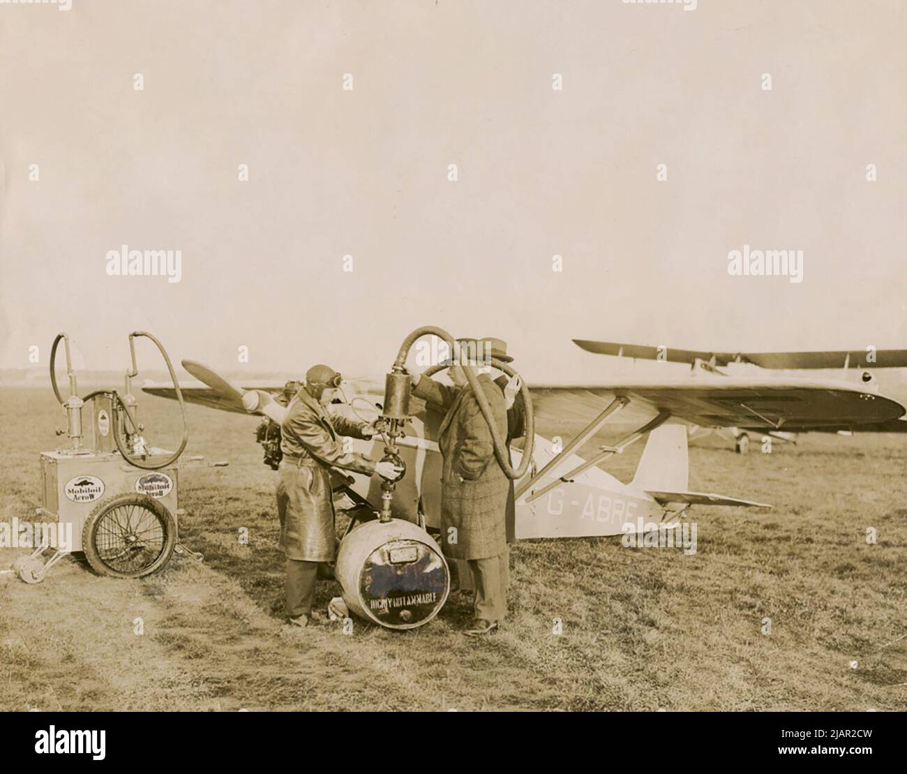 Arthur Butler refuelling the Comper Swift aeroplane G-ABRE, 1931 Stock ...