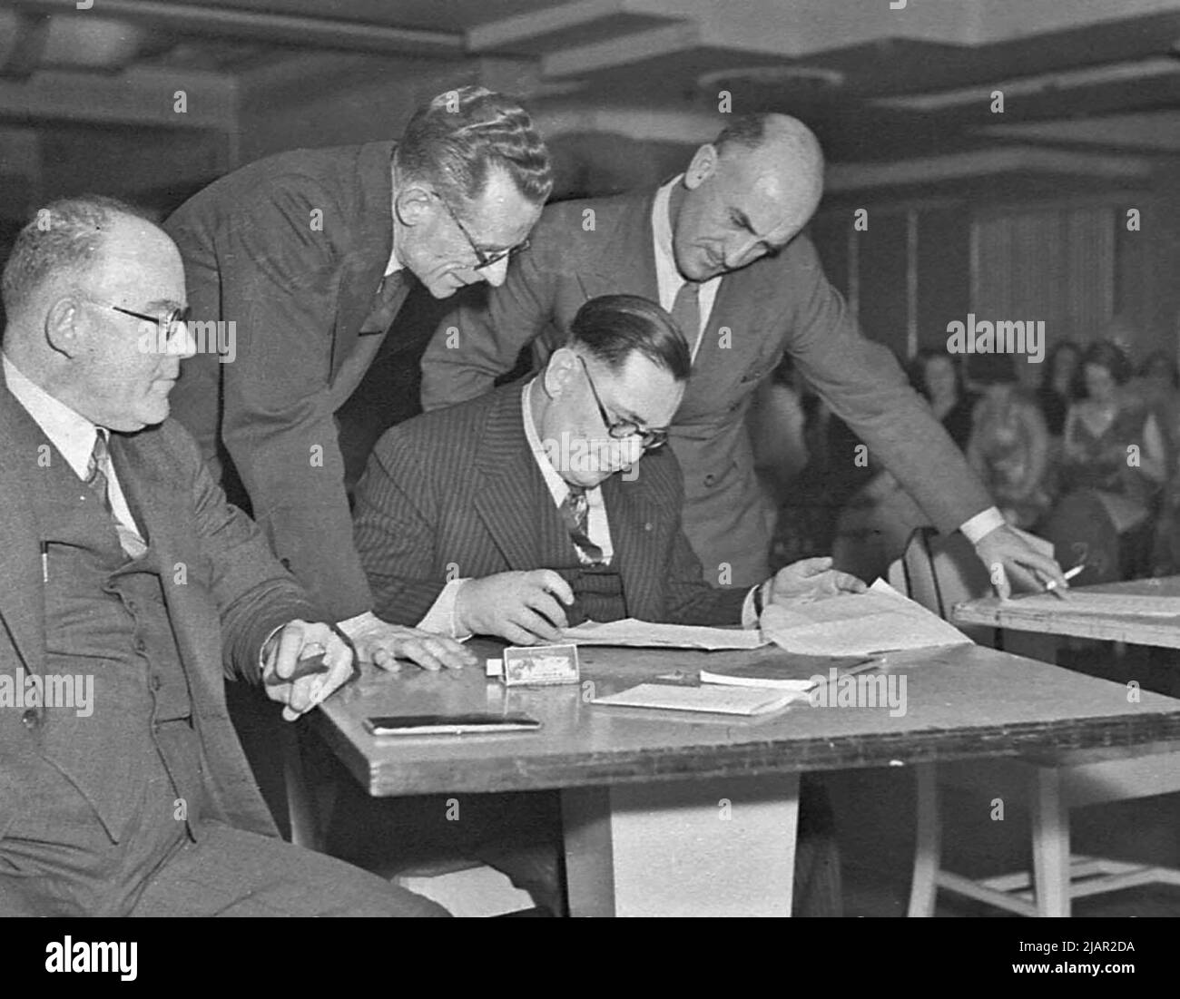 Four men looking over paperwork hi-res stock photography and images - Alamy