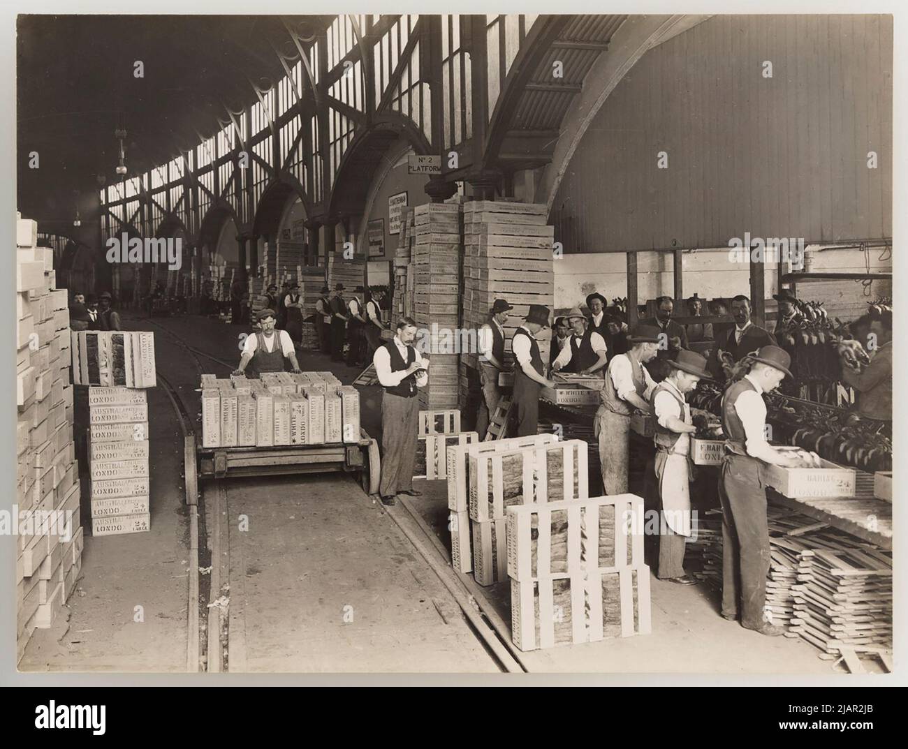 Workers in a busy factory or warehouse ca. 1921-1924 Stock Photo - Alamy