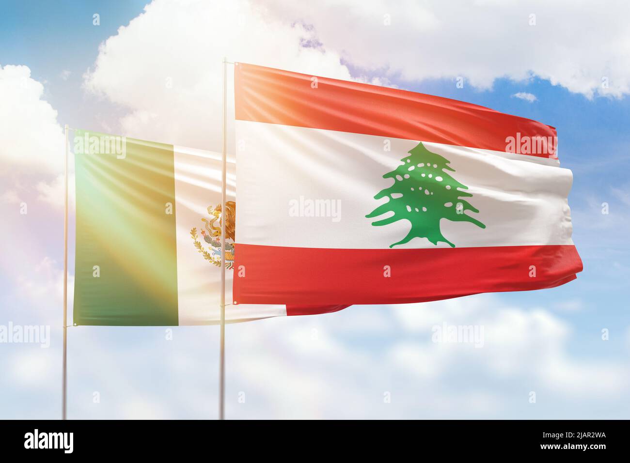Sunny blue sky and flags of lebanon and mexico Stock Photo - Alamy