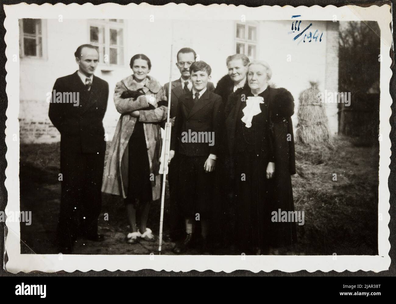 A group of six people of all ages standing against the background of a ...