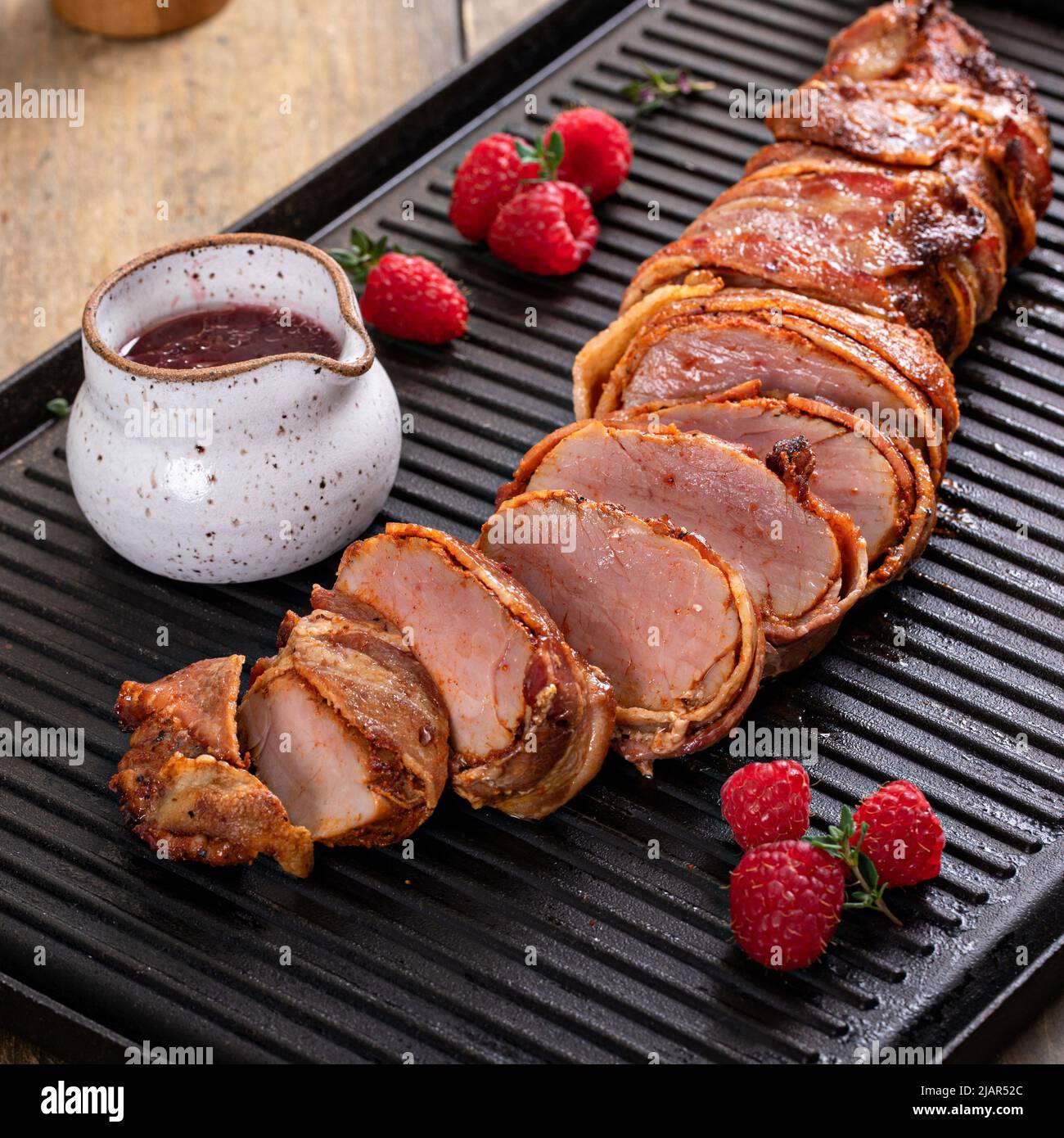Bacon wrapped pork tenderloin with raspberry vinaigrette Stock Photo ...