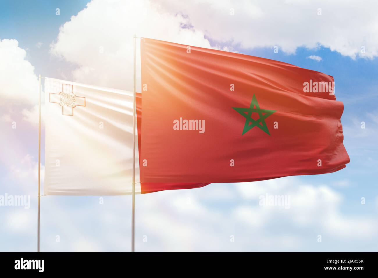 Sunny blue sky and flags of morocco and malta Stock Photo - Alamy