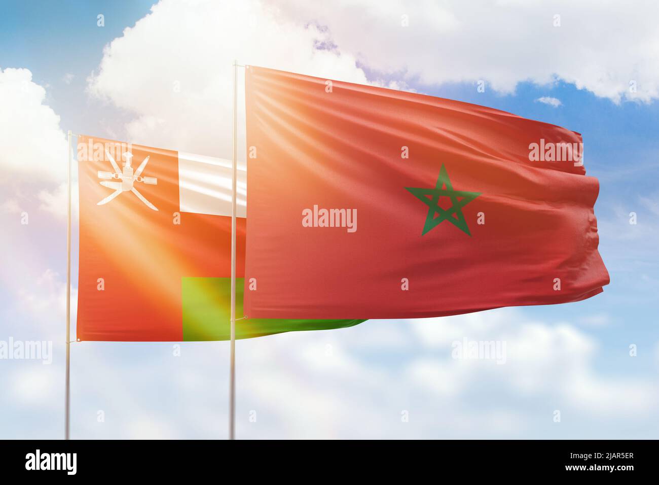 Sunny blue sky and flags of morocco and oman Stock Photo - Alamy