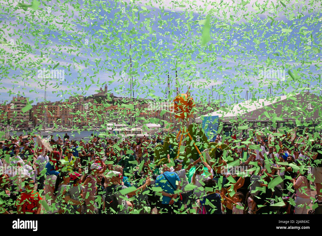 Marseille, France. 28th May, 2022. Carnival-goers parade under a shower ...