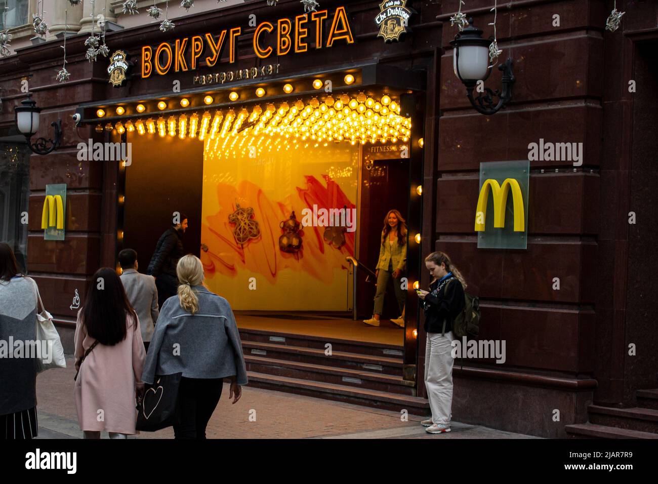 Moscow, Russia. 30th May, 2022. People pass by McDonaldís sign near the ...