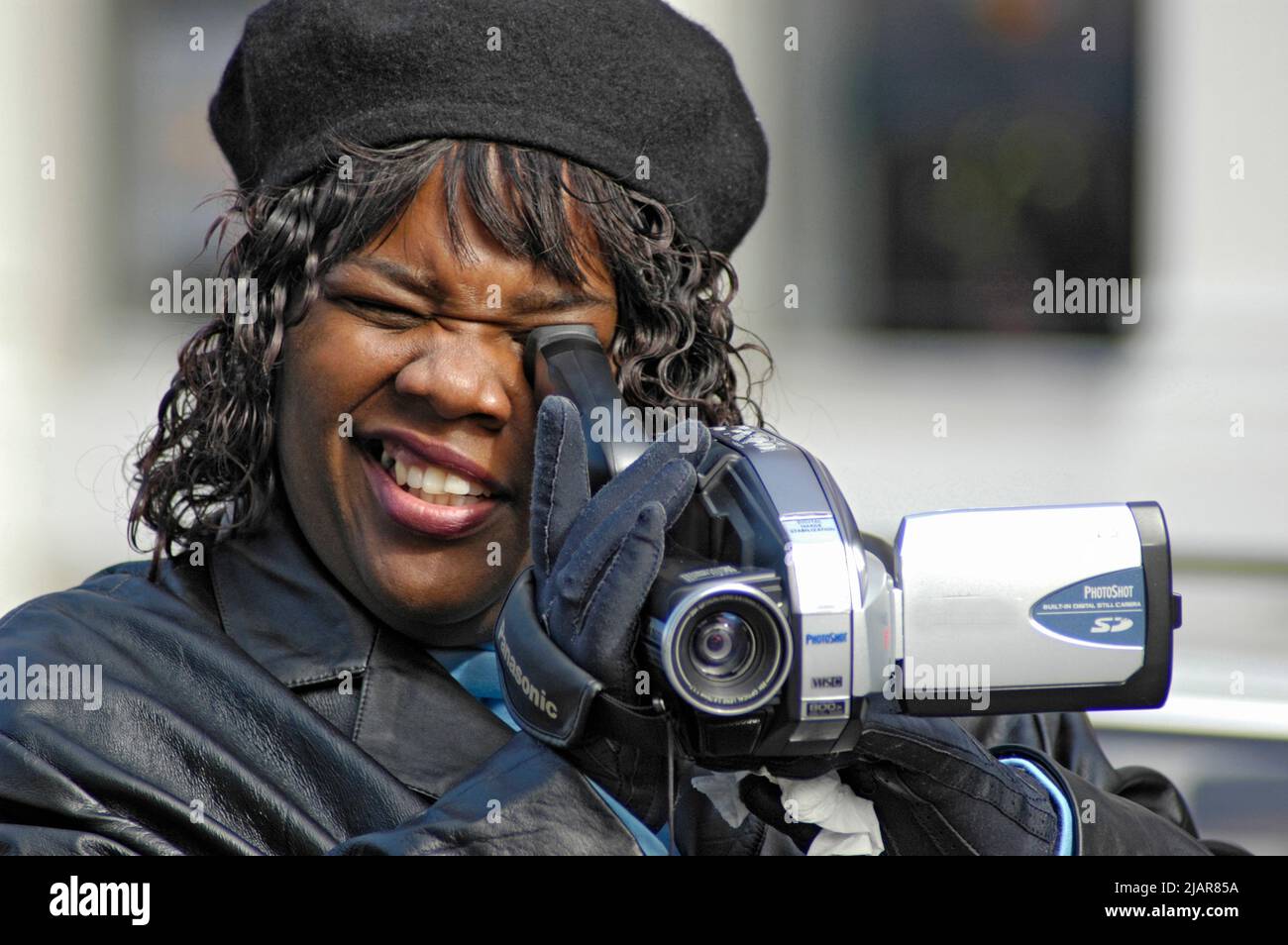Older ethnic black woman making videos of family at a January march in ...