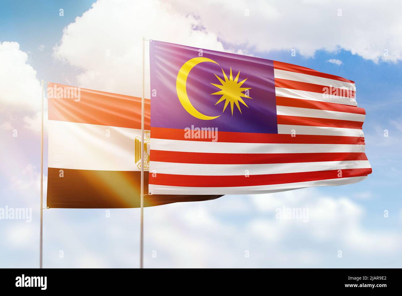 Sunny blue sky and flags of malaysia and egypt Stock Photo - Alamy